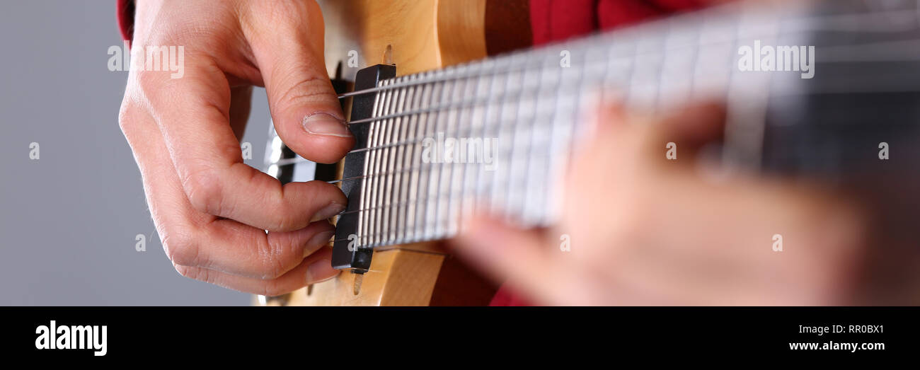 Male arms playing classic shape electric guitar Stock Photo - Alamy