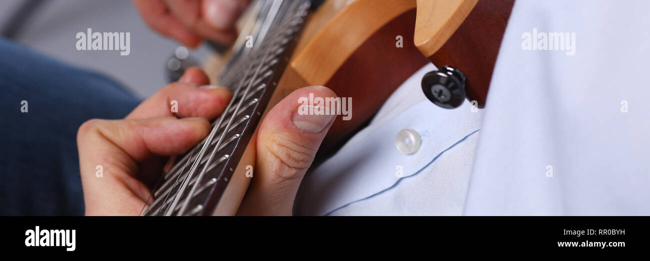 Male arms playing classic shape electric guitar Stock Photo - Alamy