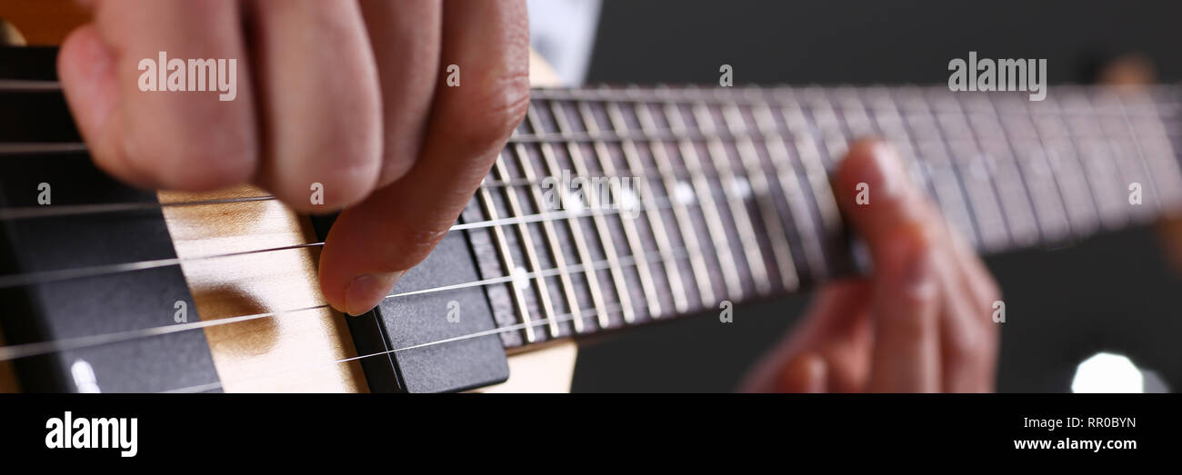 Male arms playing classic shape electric guitar Stock Photo - Alamy