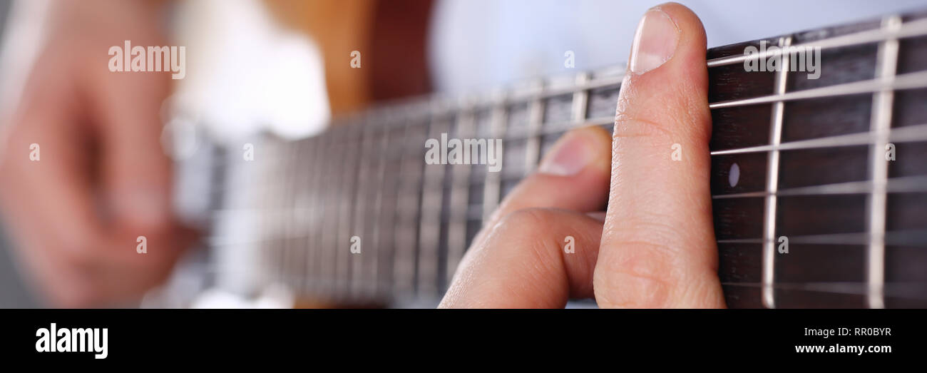 Male arms playing classic shape electric guitar Stock Photo - Alamy