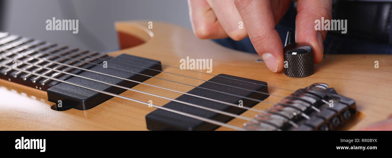 Male arms playing classic shape electric guitar Stock Photo - Alamy