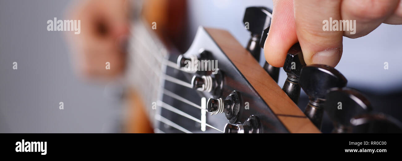 Male arms playing classic shape electric guitar Stock Photo - Alamy