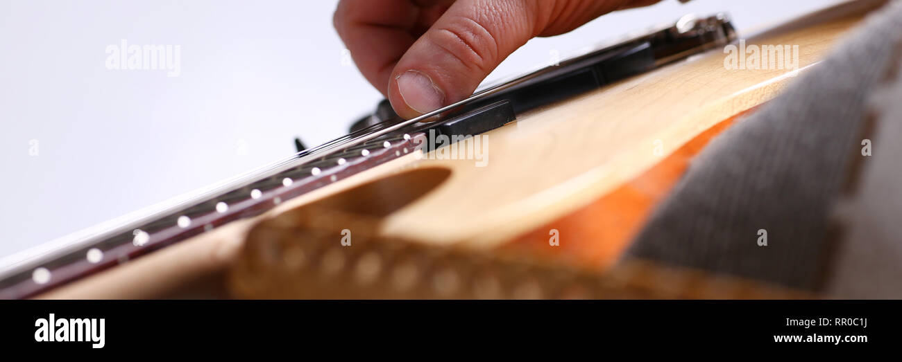 Male arms playing classic shape electric guitar Stock Photo - Alamy