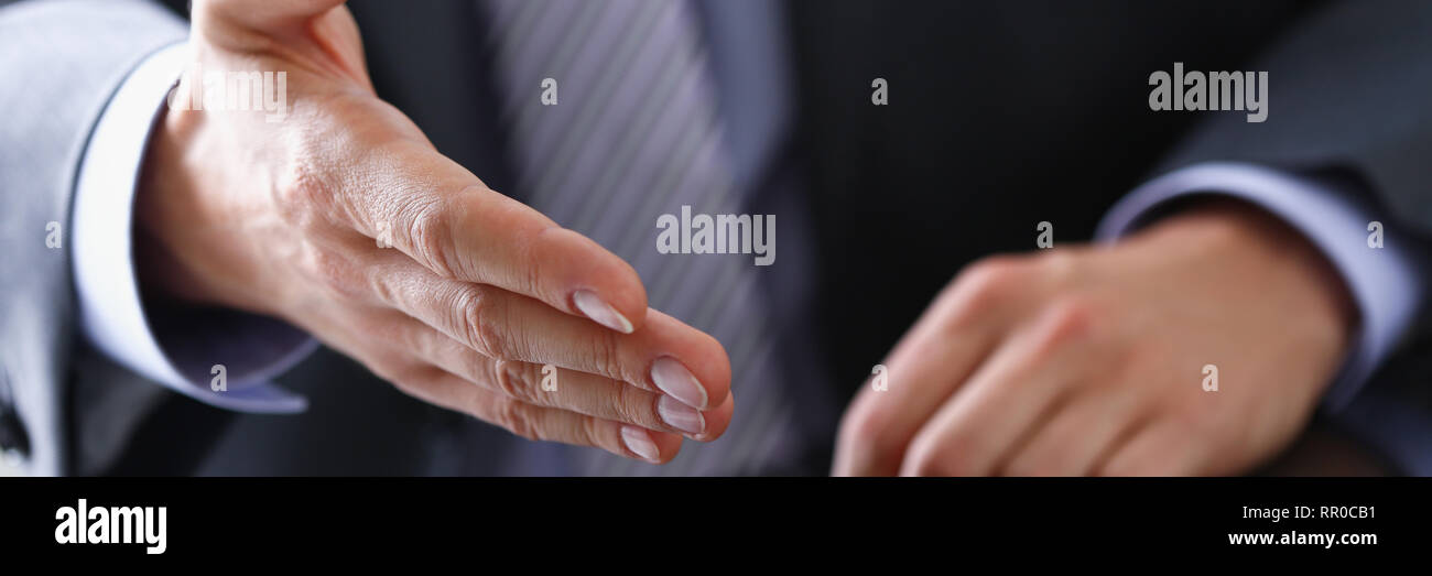 Man in suit and tie give hand as hello Stock Photo - Alamy