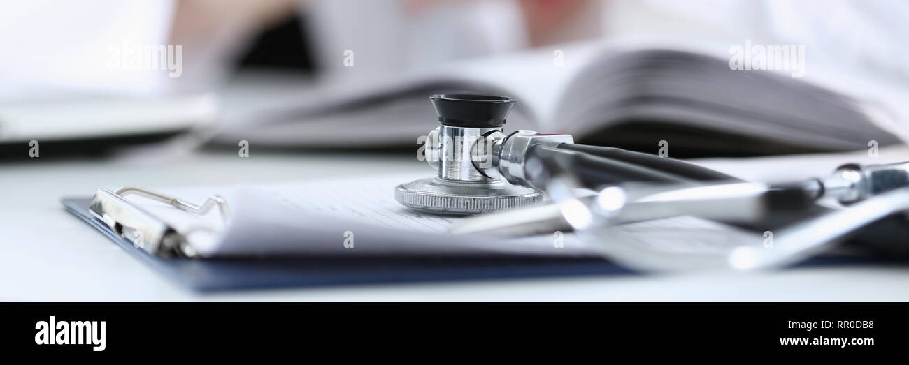 Stethoscope head lying on medical forms closeup Stock Photo - Alamy