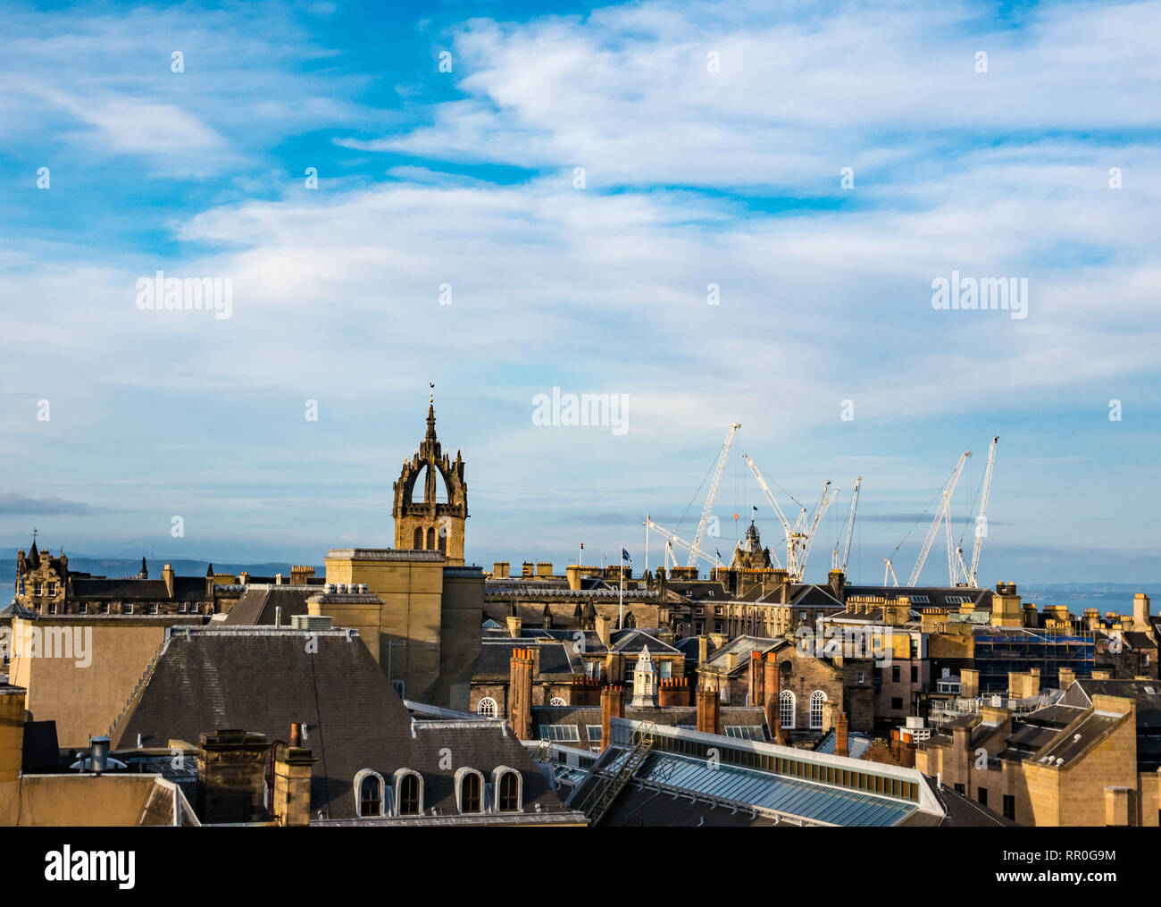 Rooftop view and chimneys, Old Town, Edinburgh city centre with cranes ...