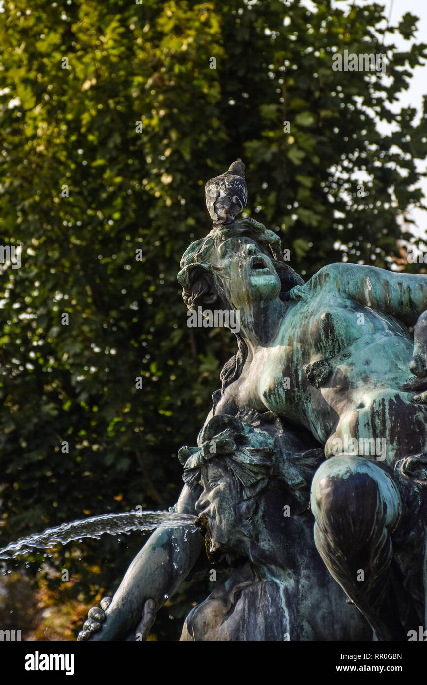 Pigeon over statue covered with poop ilustrating the animal diseases ...