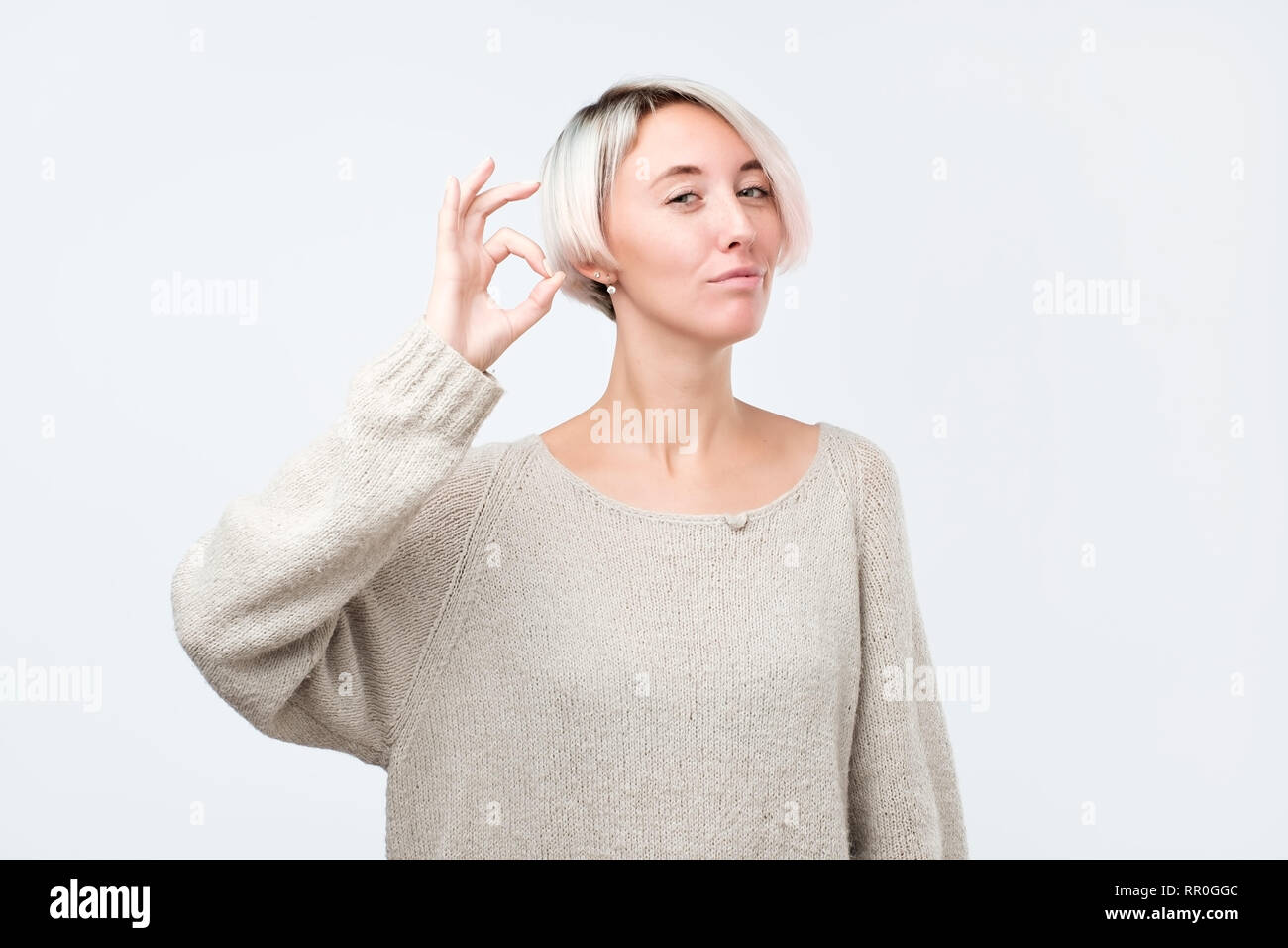 Attractive young adult woman showing ok sign. Expression emotion and ...