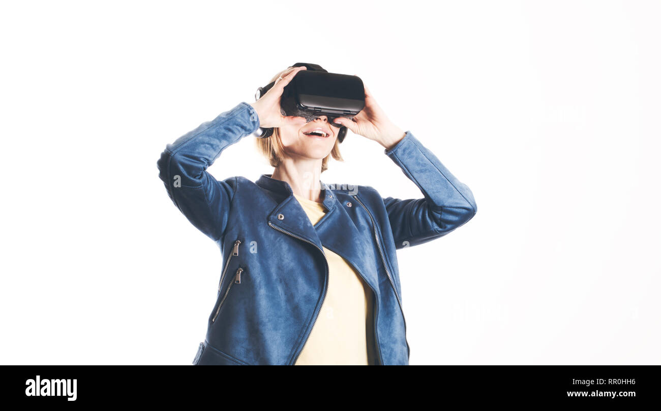 A Young Woman Is Wearing Virtual Reality Glasses And Reaching For Something With His Hands Stock