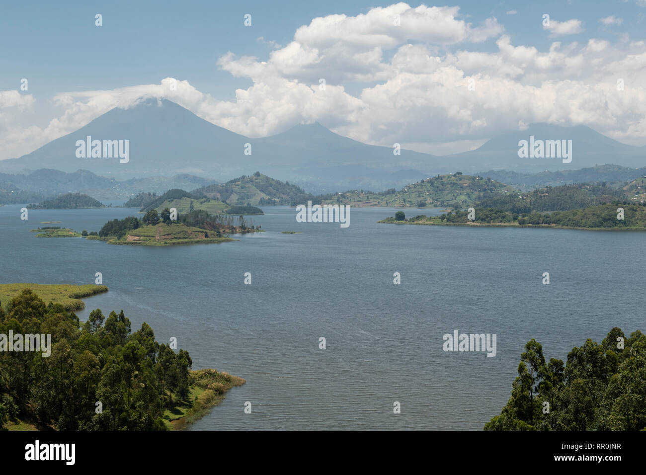 Lake Mutanda with views of volcanoes of the Virunga Mountains, Uganda ...