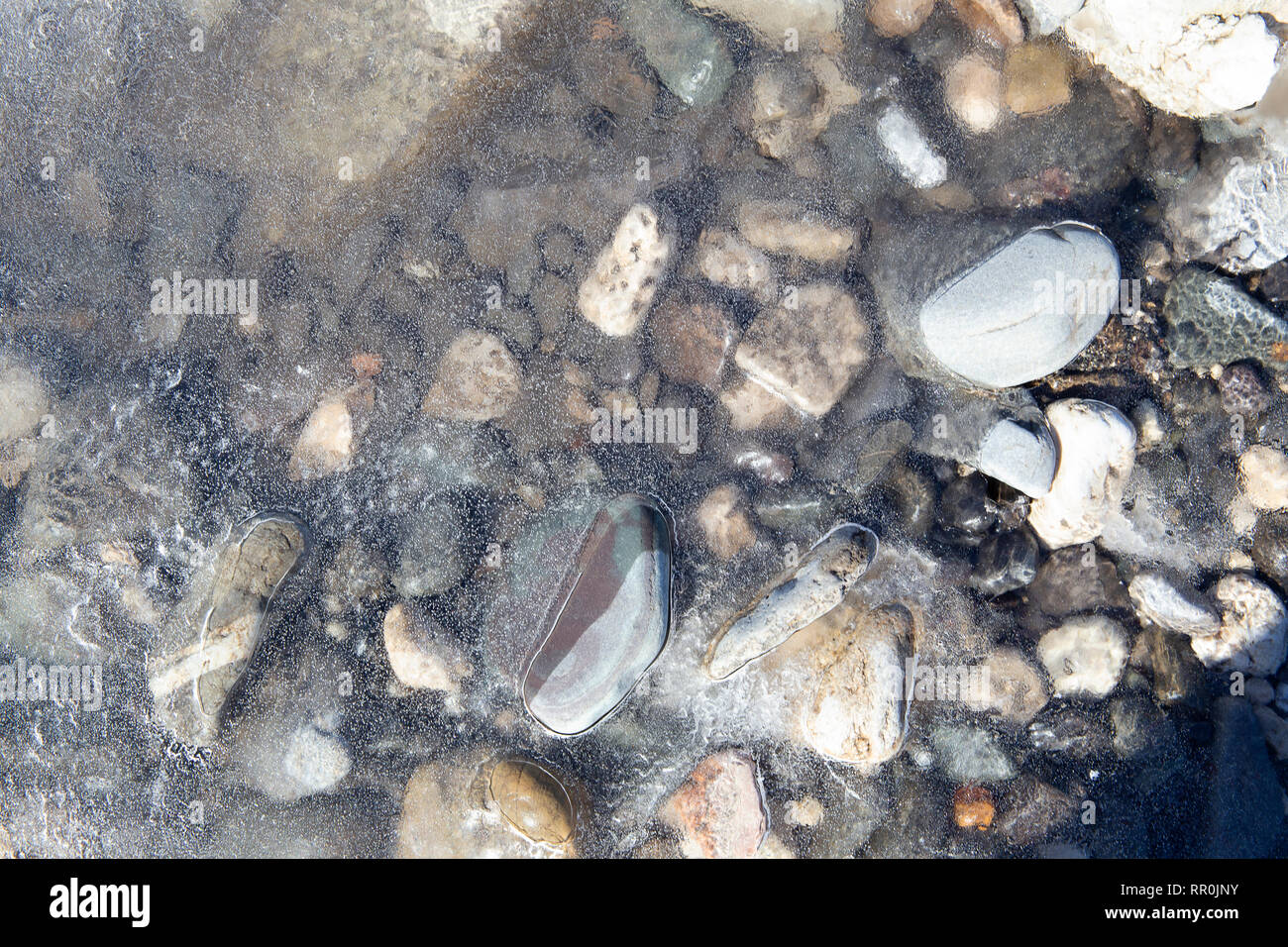 Pebble covered with ice Stock Photo - Alamy