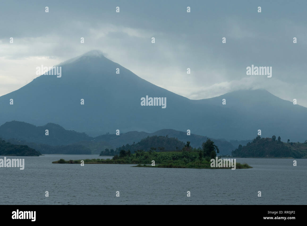 Lake Mutanda with views of volcanoes of the Virunga Mountains, Uganda ...
