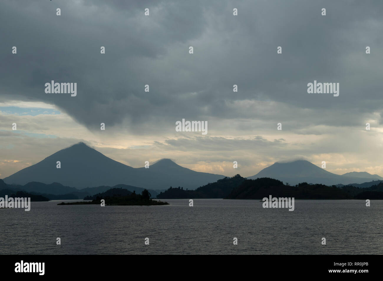 Lake Mutanda with views of volcanoes of the Virunga Mountains, Uganda ...