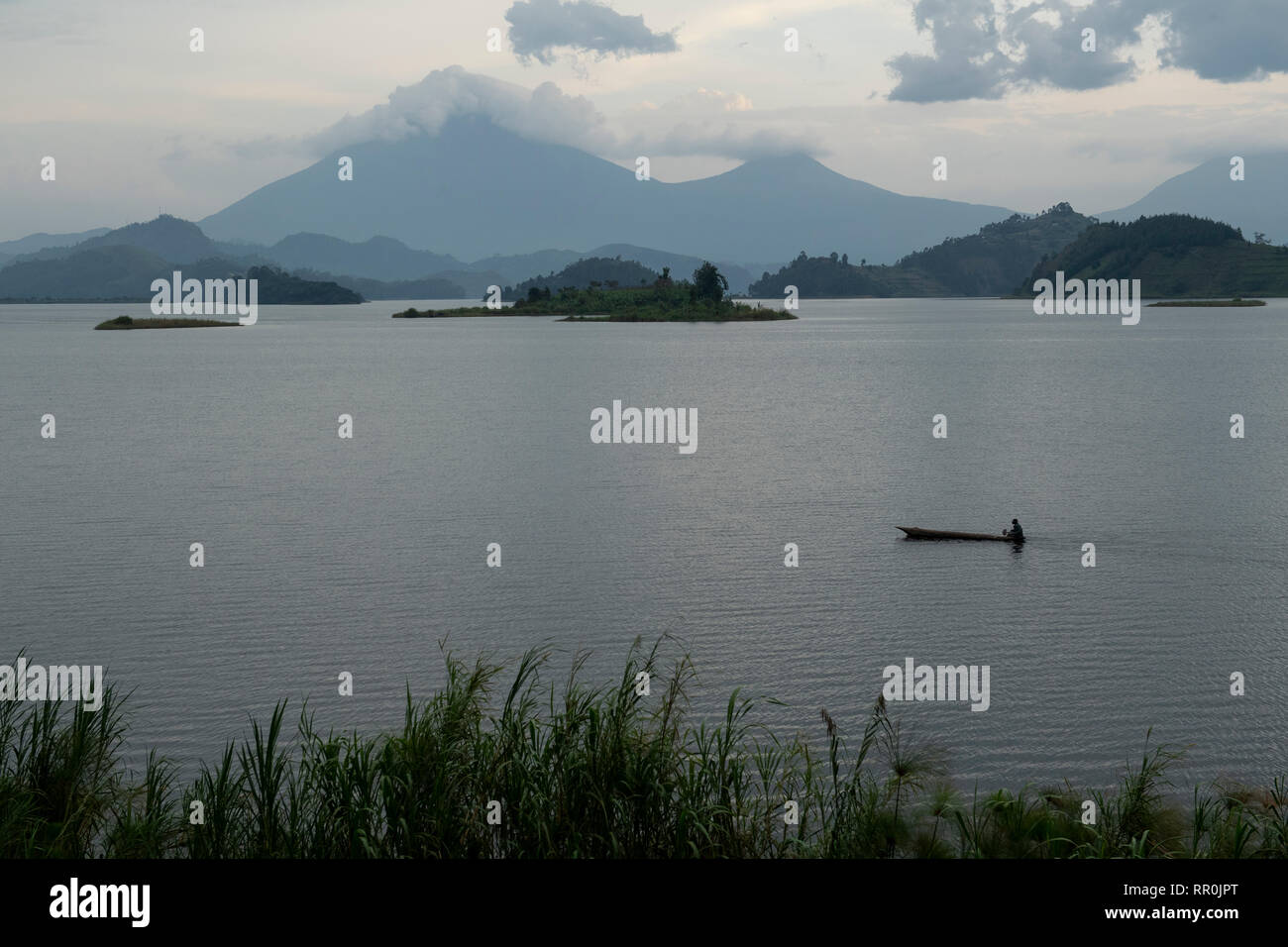 Lake Mutanda with views of volcanoes of the Virunga Mountains, Uganda ...