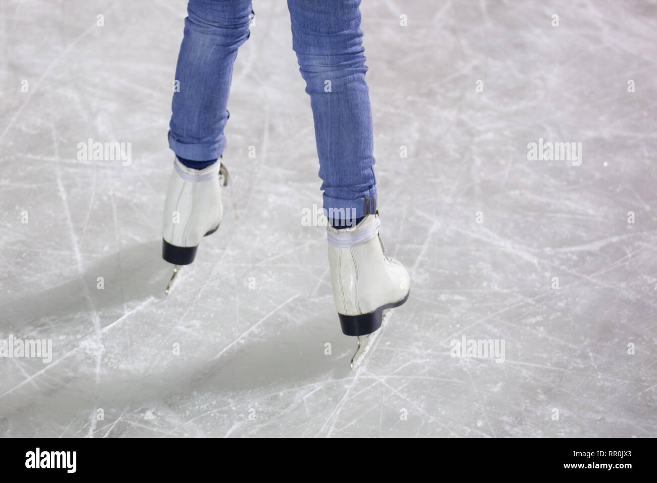 feet on the skates of a person rolling on the ice rink Stock Photo - Alamy