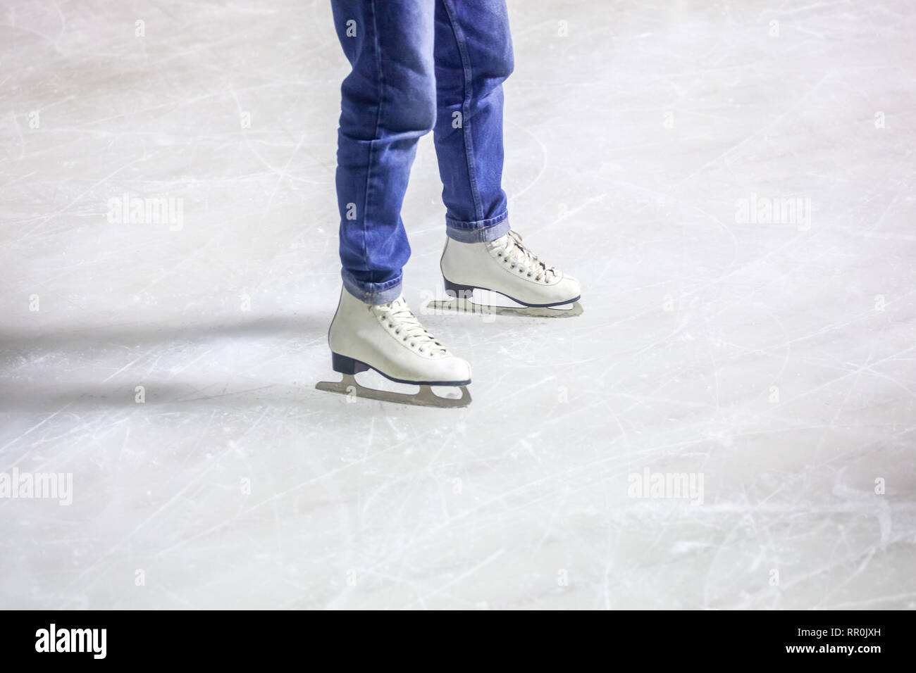 feet on the skates of a person rolling on the ice rink Stock Photo - Alamy
