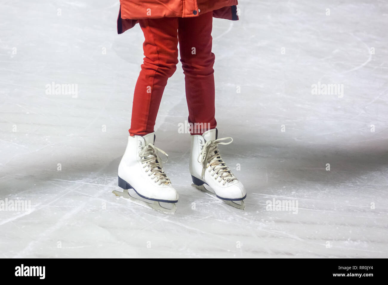 feet on the skates of a person rolling on the ice rink Stock Photo - Alamy