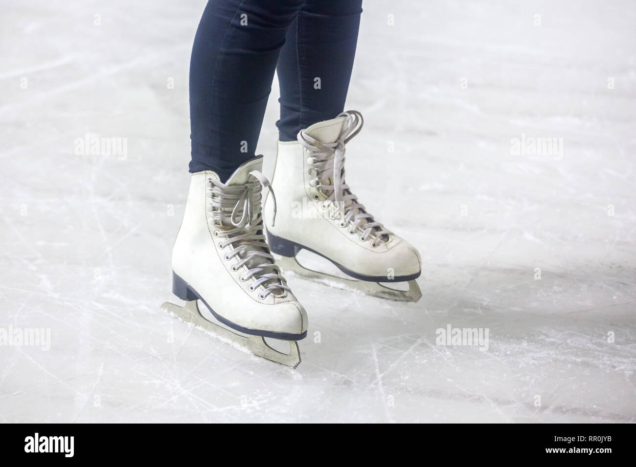 feet on the skates of a person rolling on the ice rink Stock Photo - Alamy