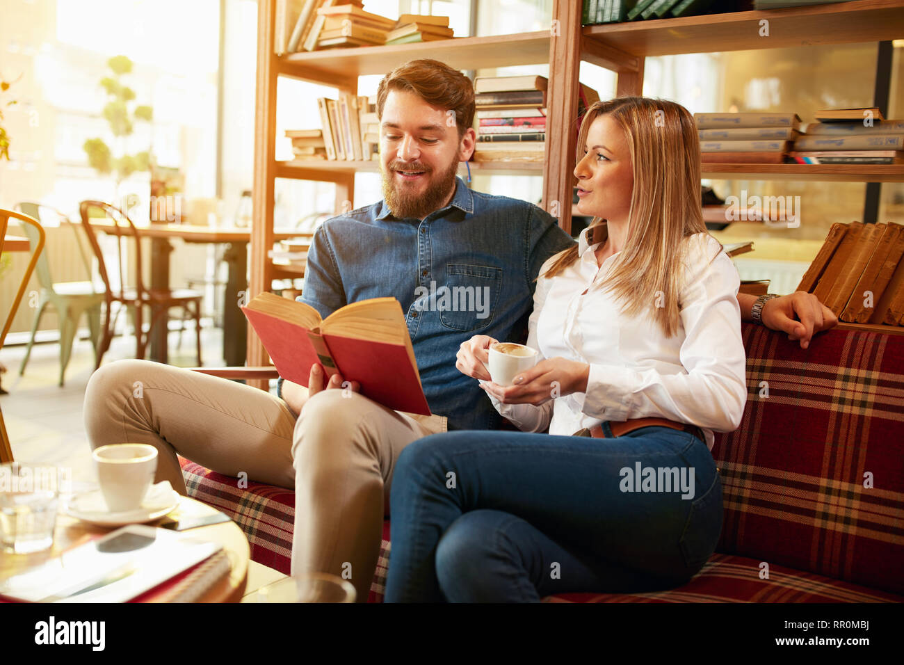 Students couple learn together and drinks coffee indoor Stock Photo - Alamy