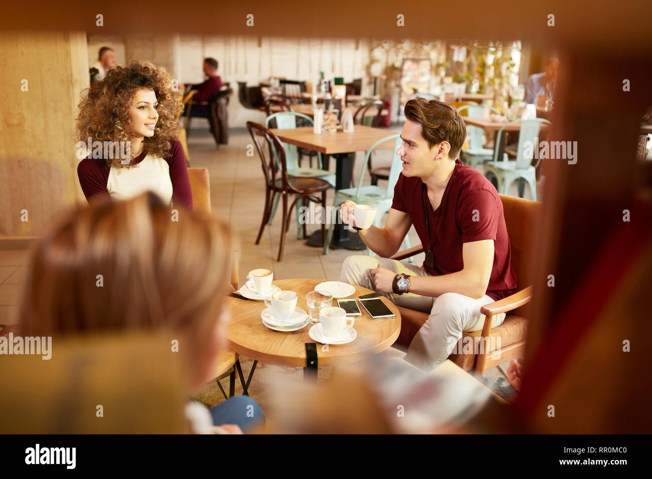 Young people drinking coffee in students restaurant Stock Photo - Alamy