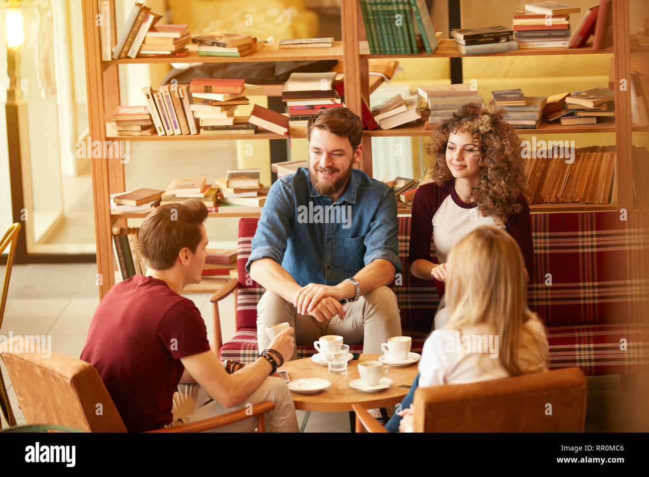 Young people drinking coffee in student club Stock Photo - Alamy