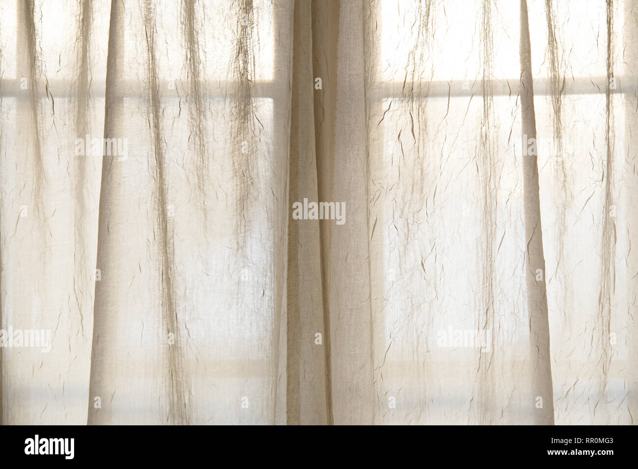 Sheer fabric window curtain with filtered light Stock Photo - Alamy