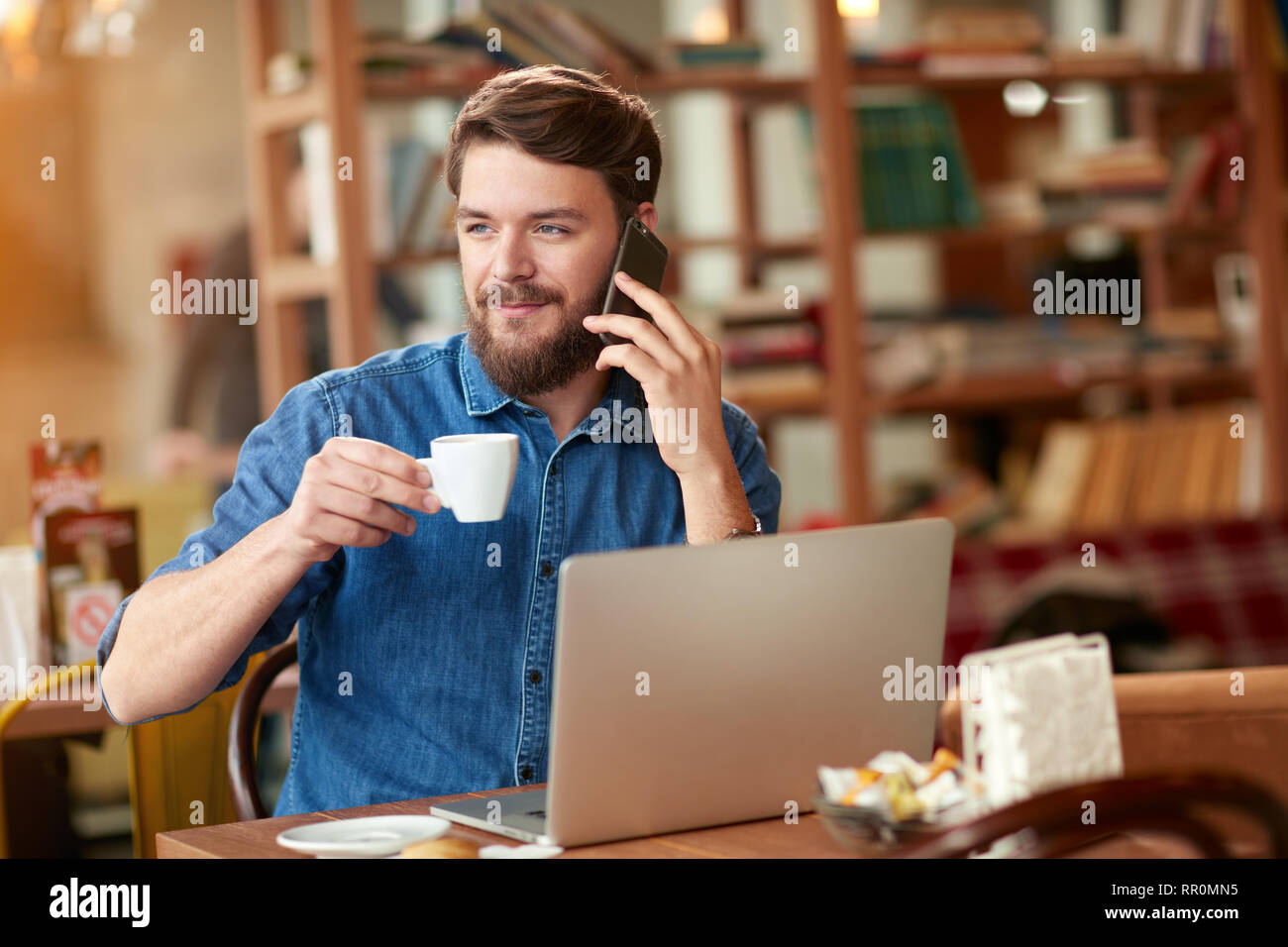 Guy in cafe talking on hi-res stock photography and images - Alamy