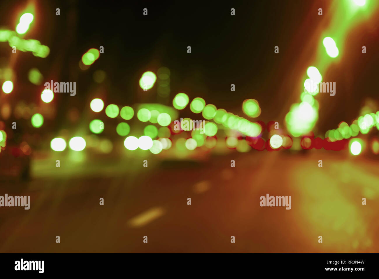 Blurred bokeh lights of the city at night, moving cars, urban neon ...