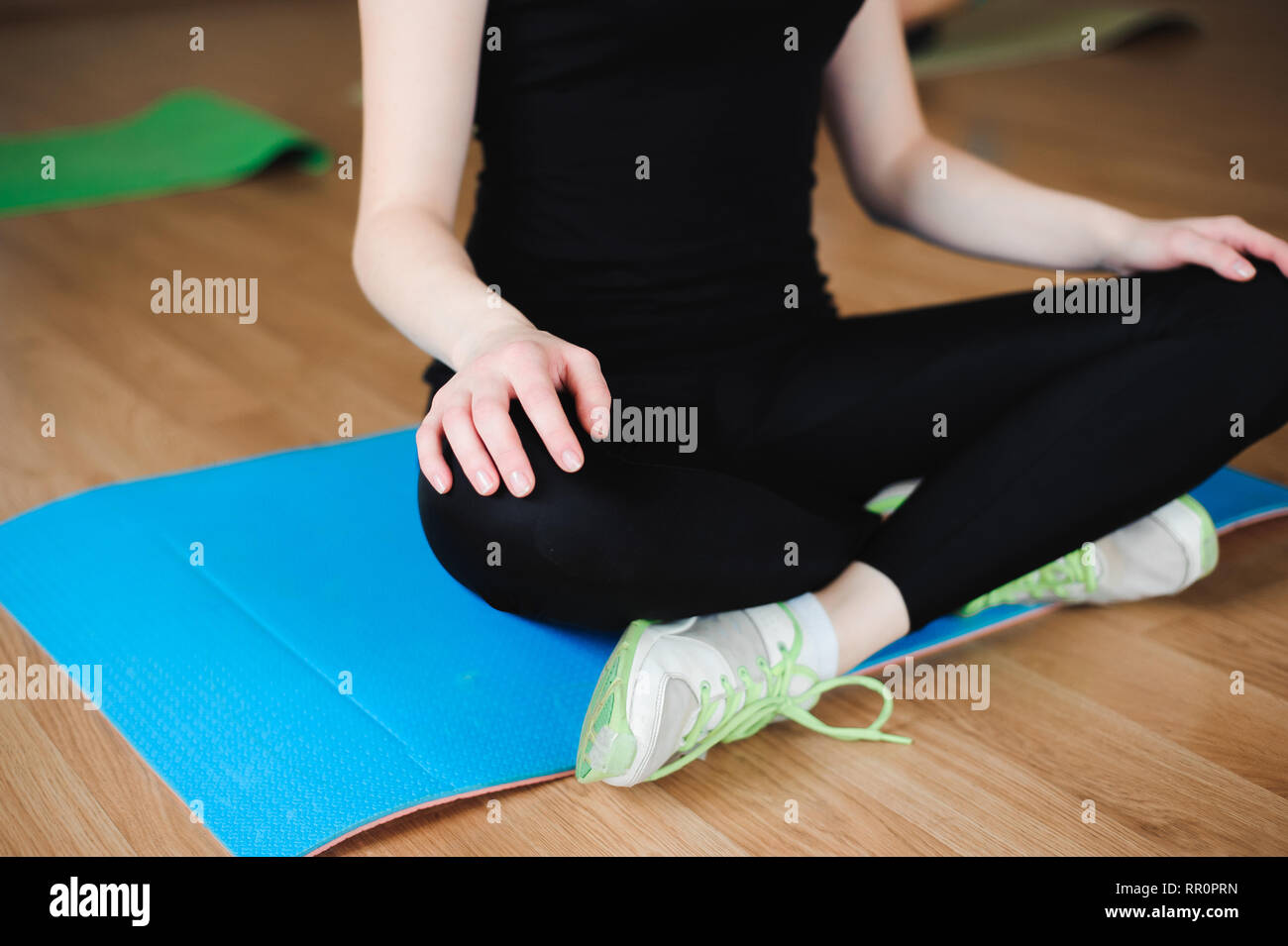 athletic woman doing relaxation exercises in gym class Stock Photo - Alamy