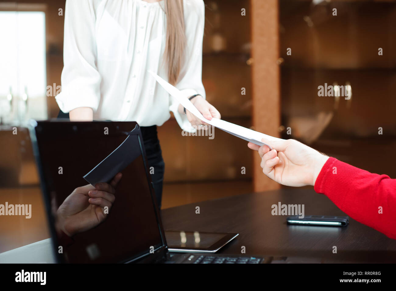 Hands of business people passing document to each other Stock Photo - Alamy