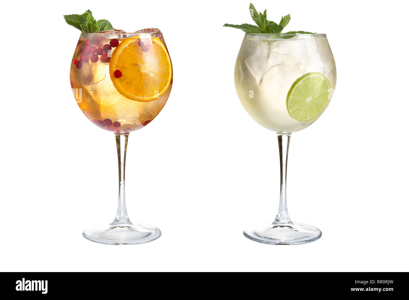 Two light alcoholic or non-alcoholic cocktails with mint, fruits and ...