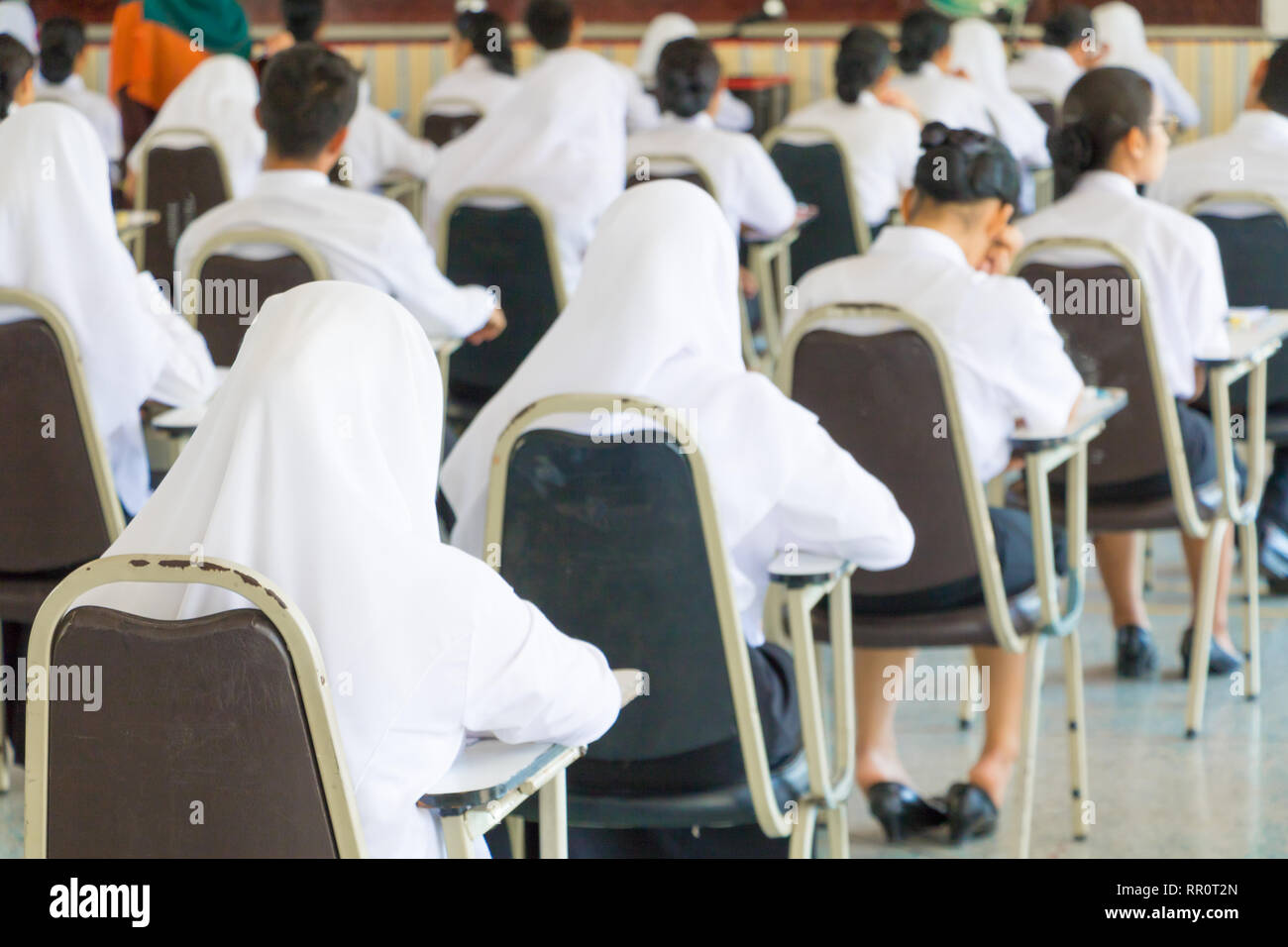 student sit chair in classroom university for education test room and ...