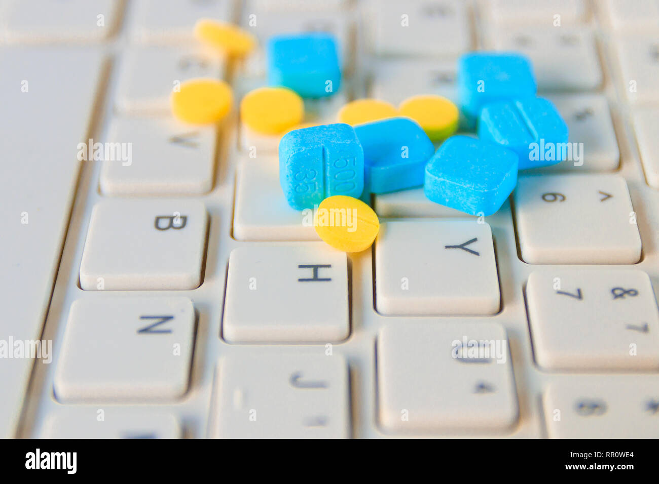 close up pills and capsule on computer keyboard white Concept with copy ...