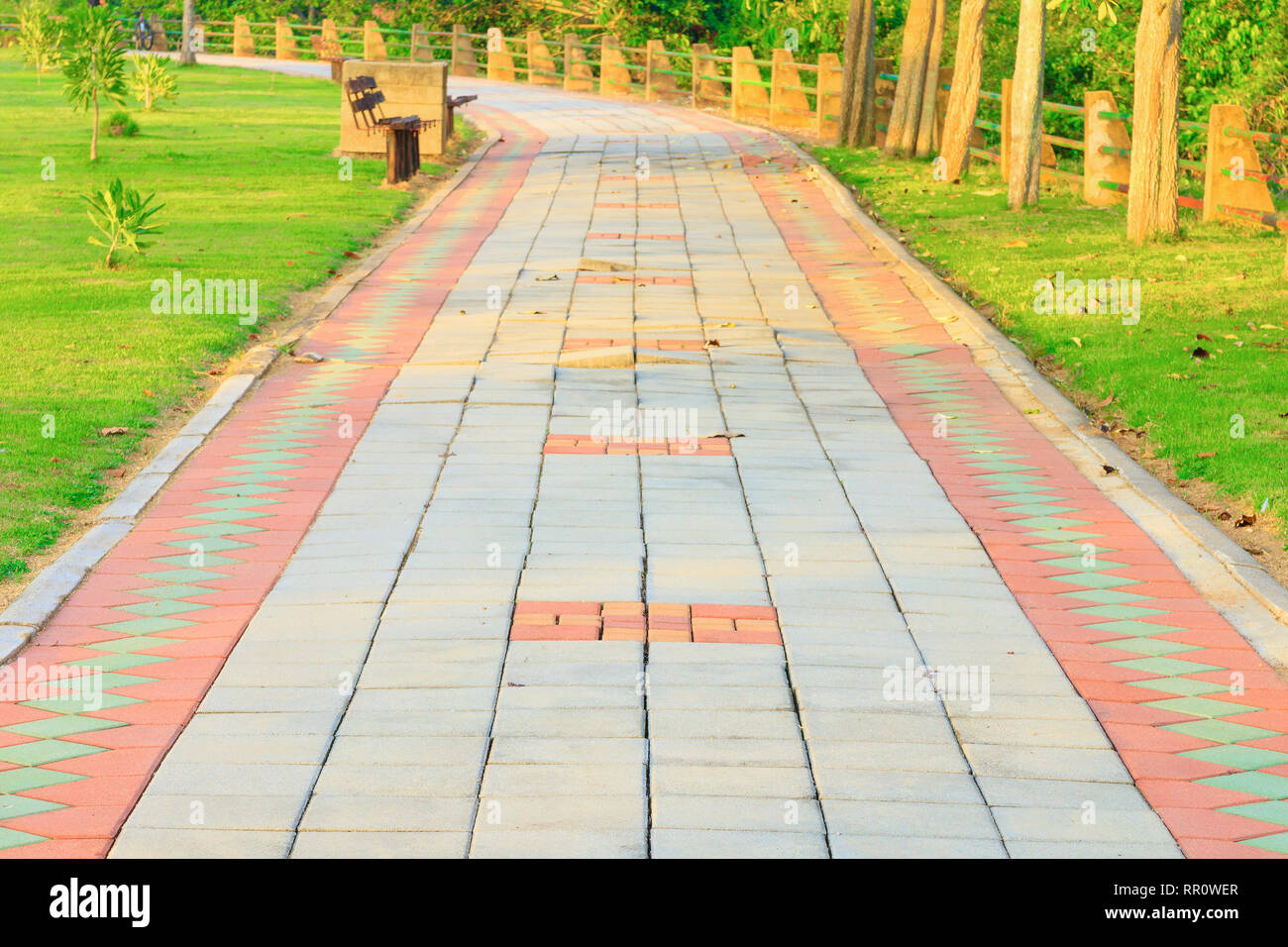 Stone block walk path in public park with sunset light tone with copy ...