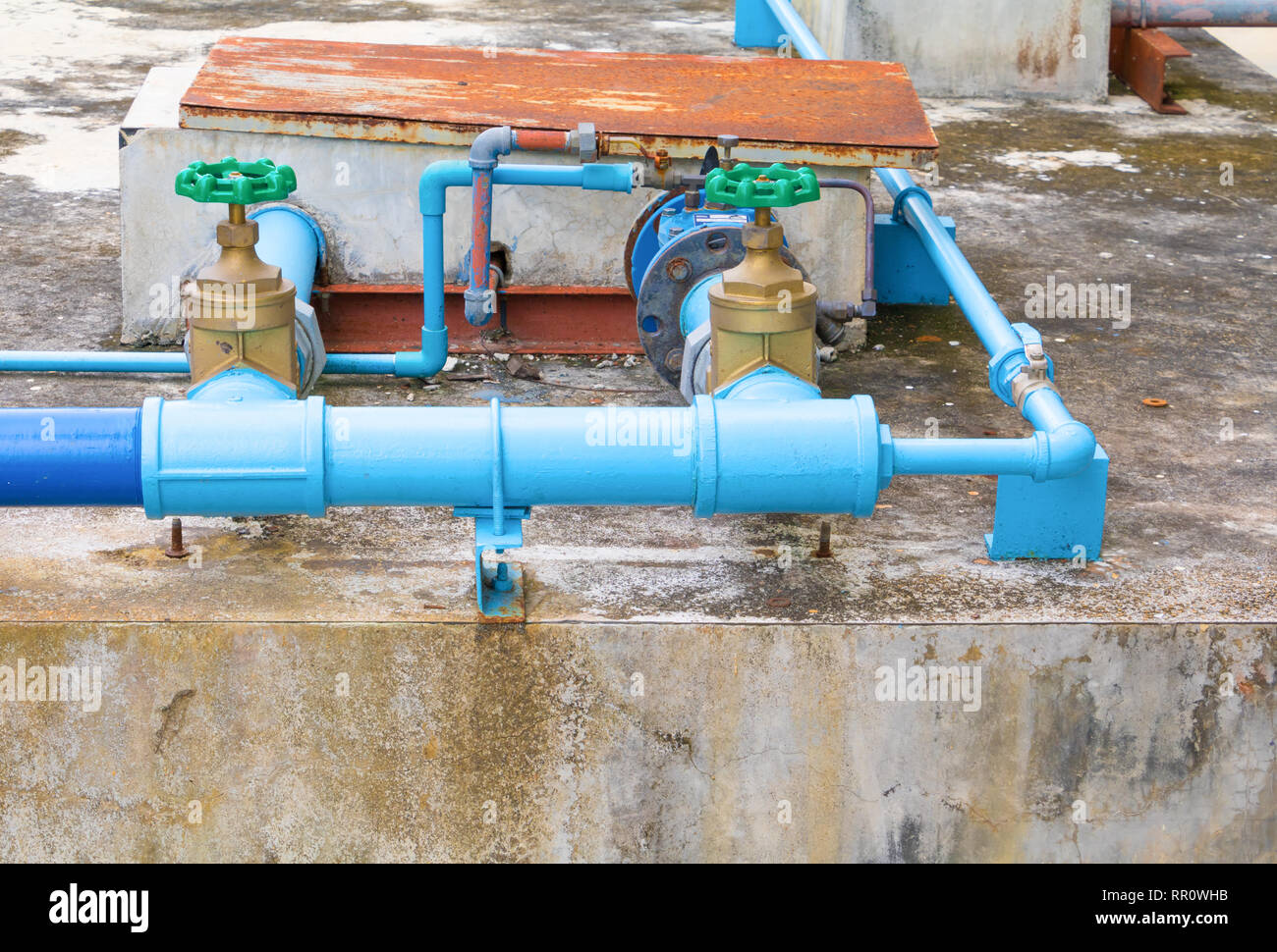 water valve plumbing joint steel tap pipe with green knob close up ...