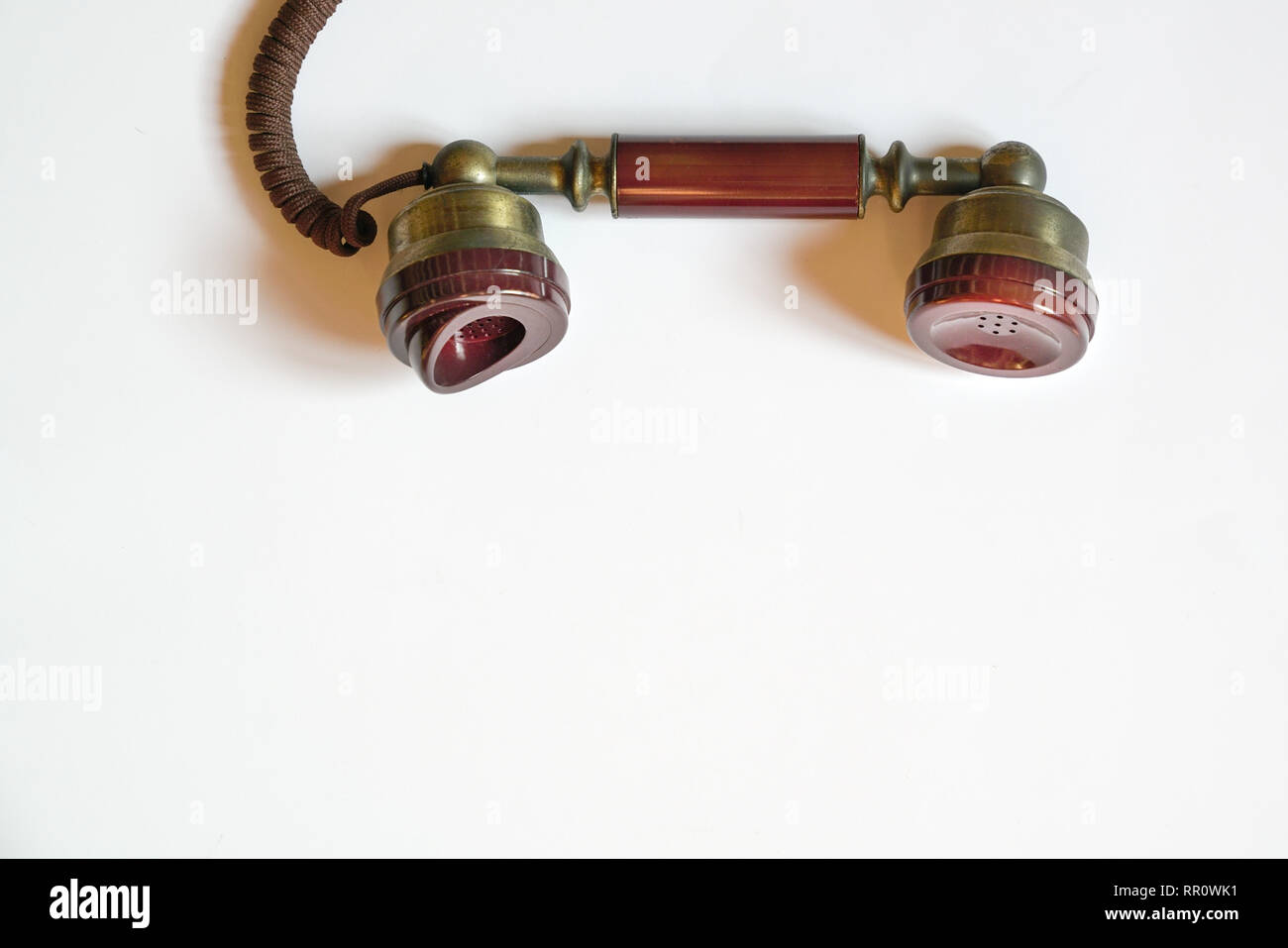 Phone call concept: a phone receiver dangling with copy space Stock ...