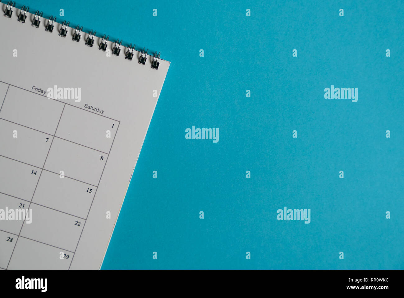 Business concept: Blue background with calendar at the side and copy ...