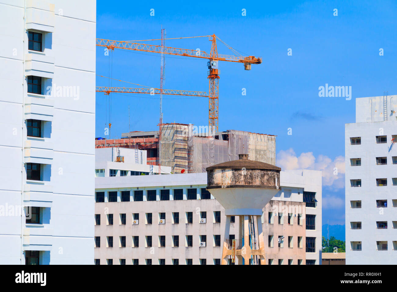 water tank and Crane Tower in construction site in develop city with ...
