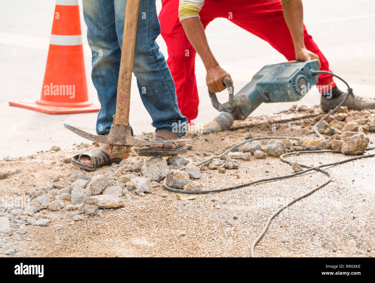 construction drilling repair worker on road surface with heavy duty ...