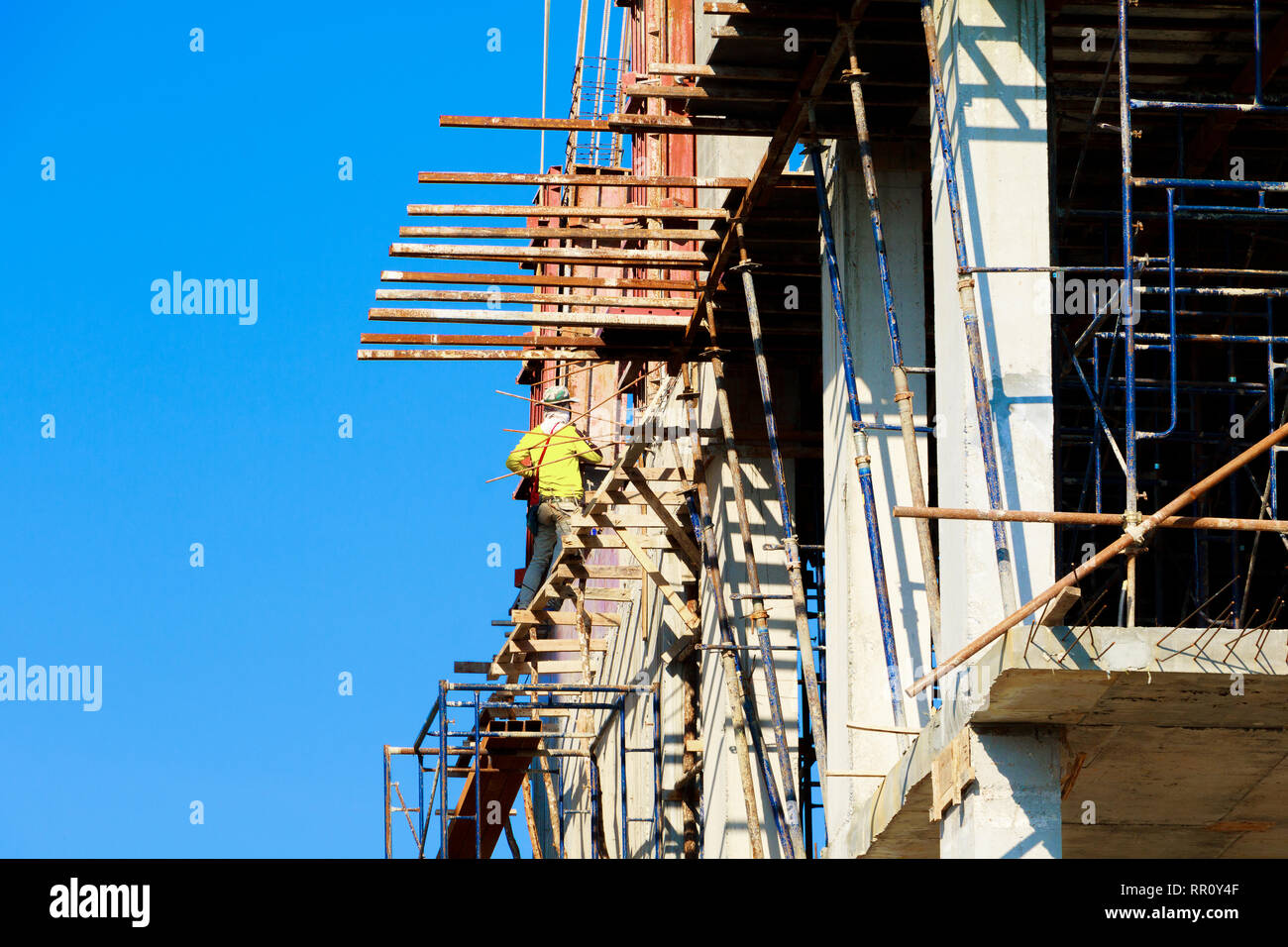 Worker work construction on high buildings site Stock Photo - Alamy