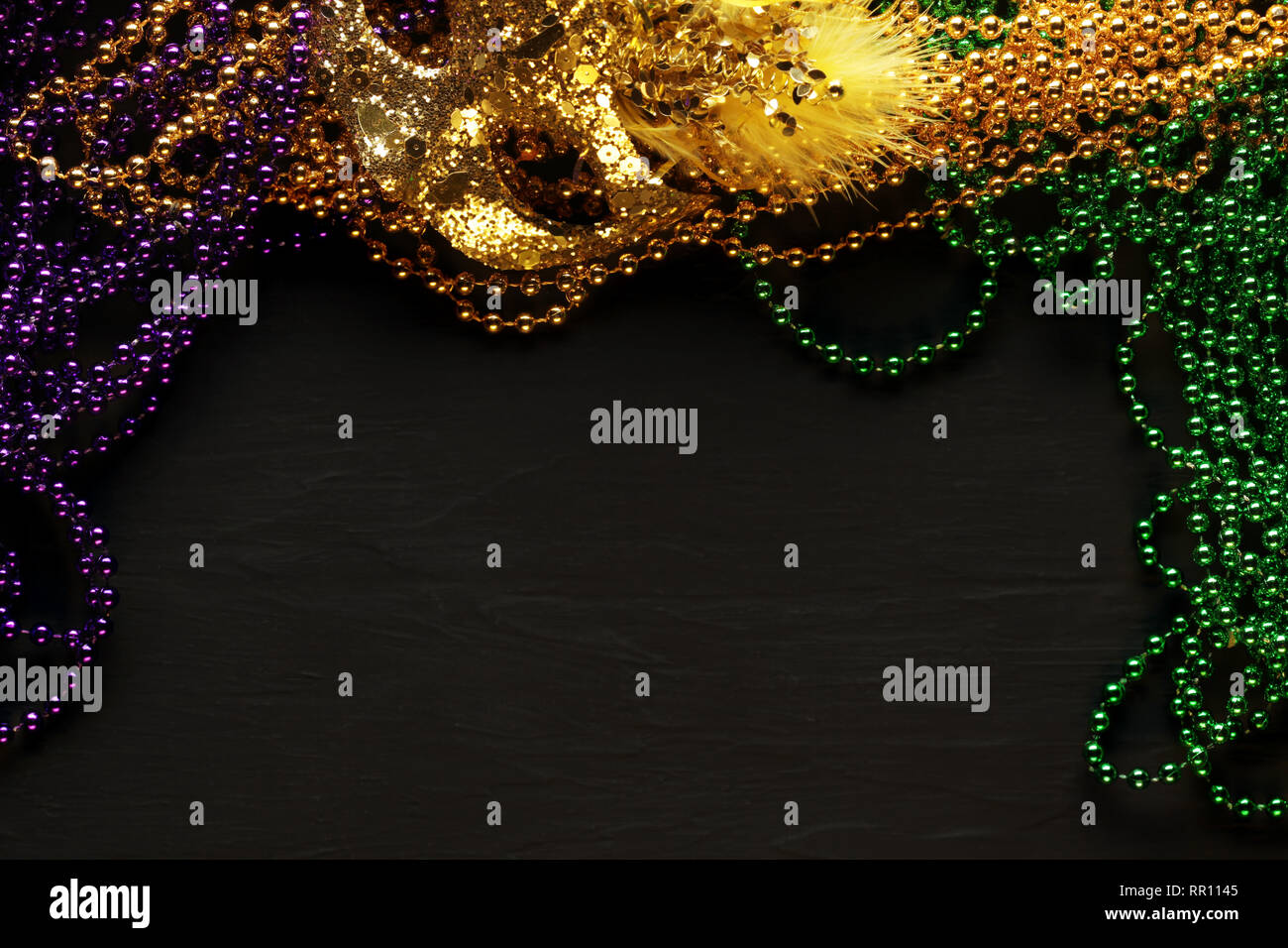 Purple, Gold, and Green Mardi Gras beads and mask background Stock ...