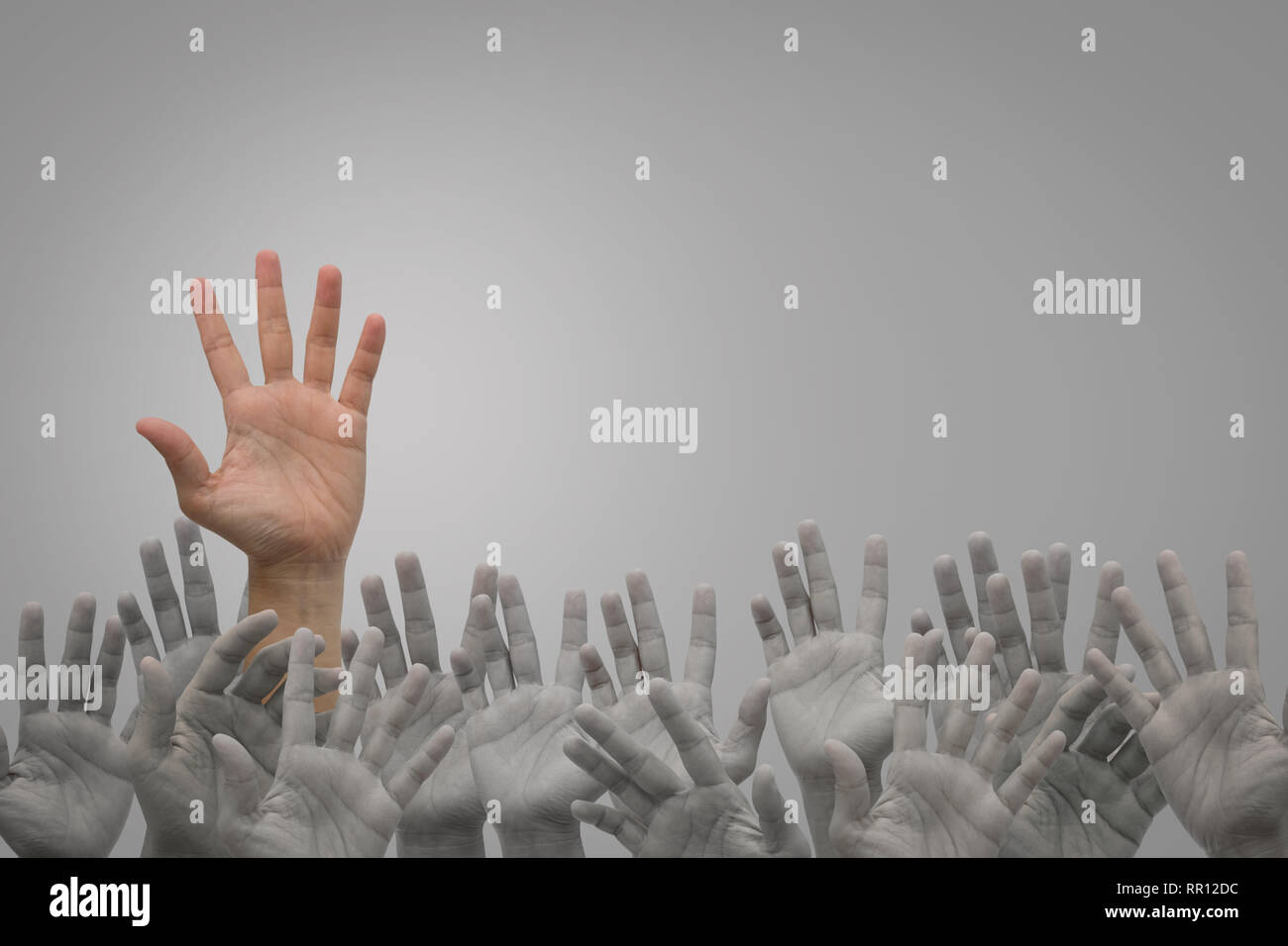 Group of human hands raised high up on grey background. Concept ...