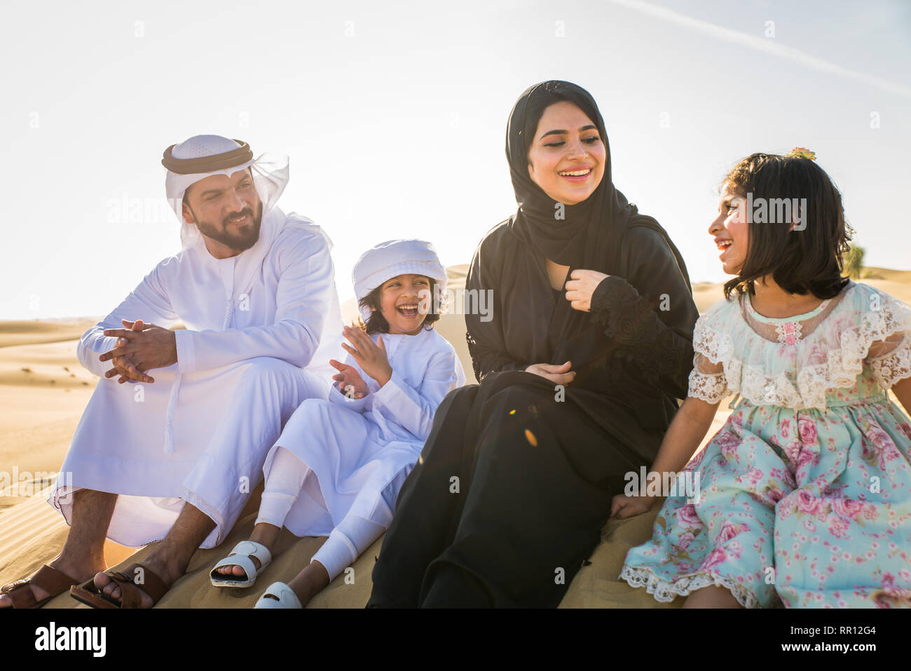 Arabian family with kids having fun in the desert - Parents and ...
