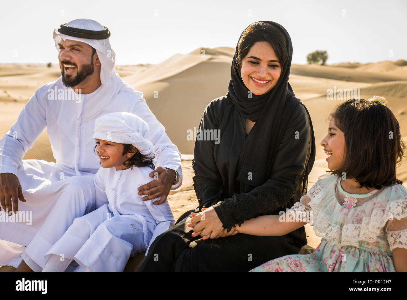 Arabian family with kids having fun in the desert - Parents and ...