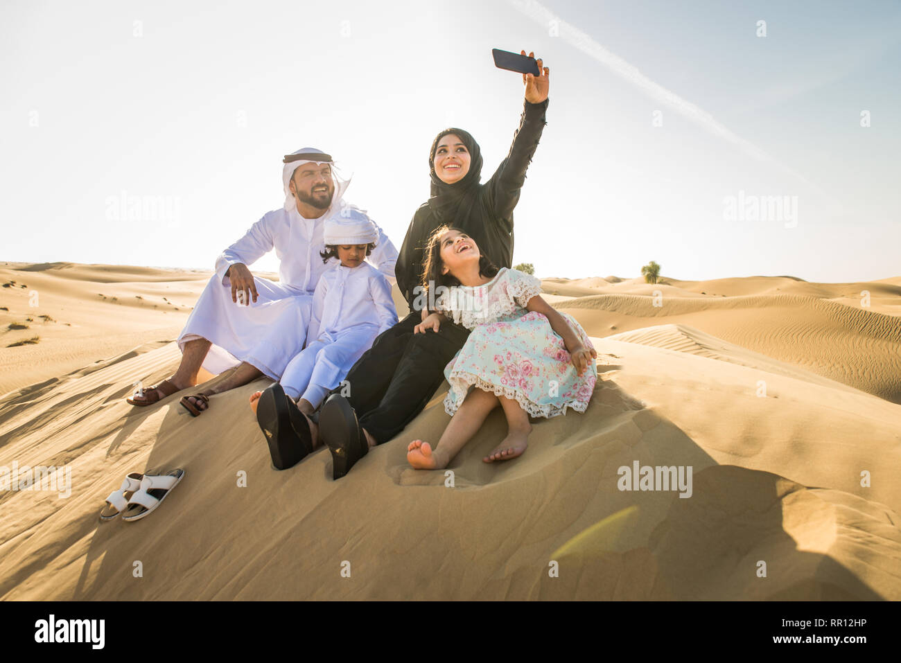 Arabian family with kids having fun in the desert - Parents and ...