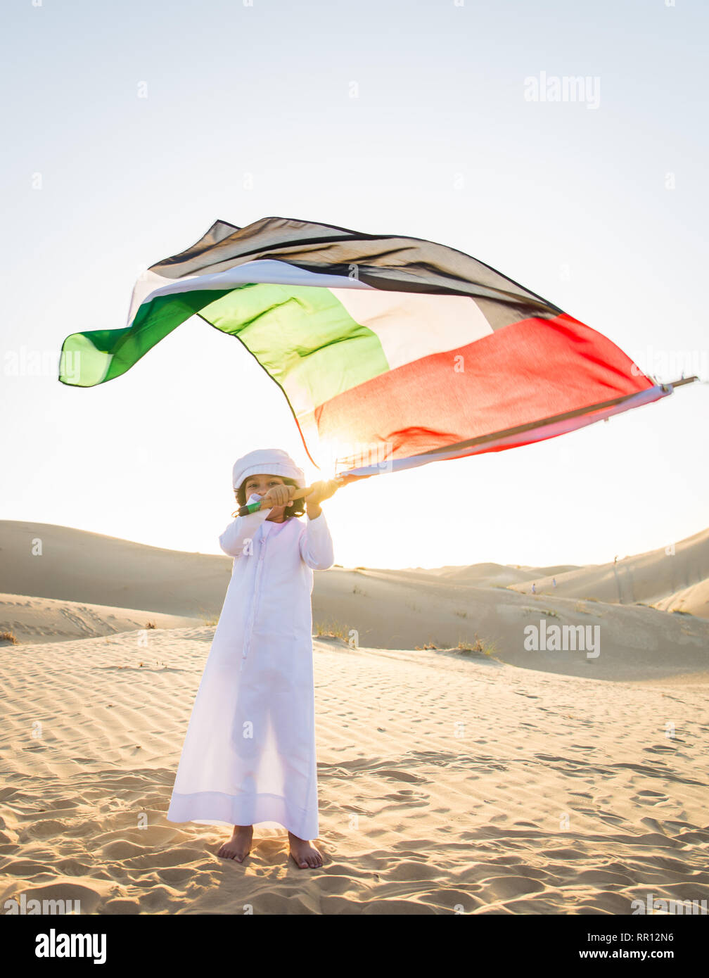 Arabian family with kids having fun in the desert - Parents and ...