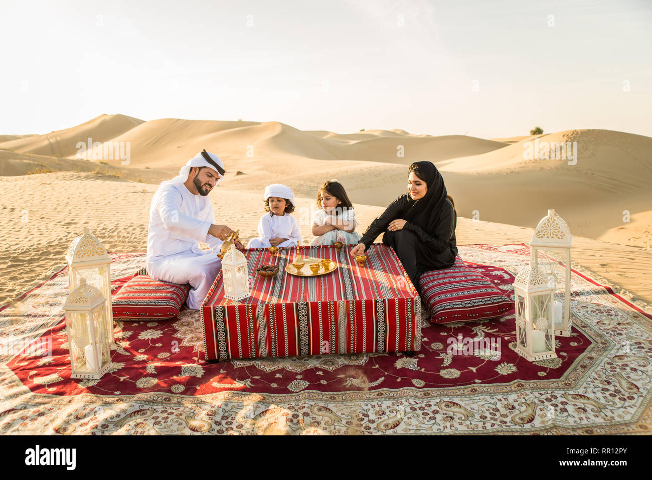 Arabian family with kids having fun in the desert - Parents and ...