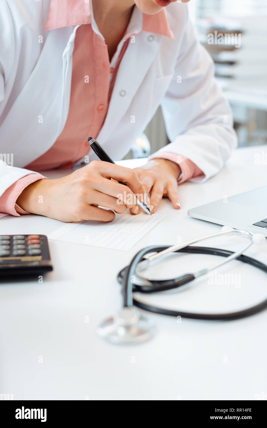 Doctor writing prescription Stock Photo - Alamy