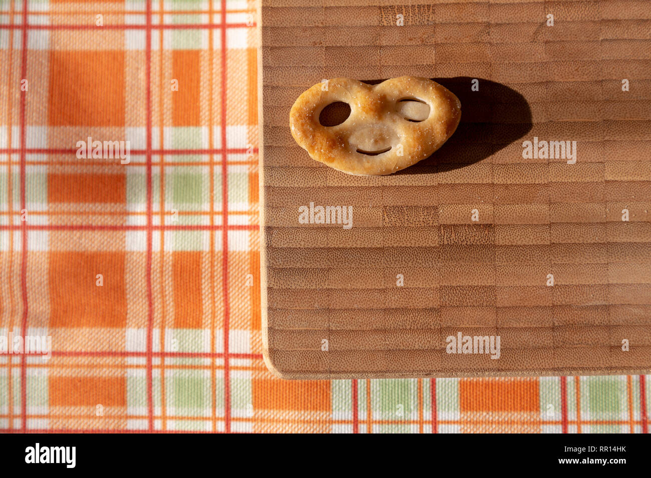 Biscuit with a defect turns into smiley face Stock Photo - Alamy
