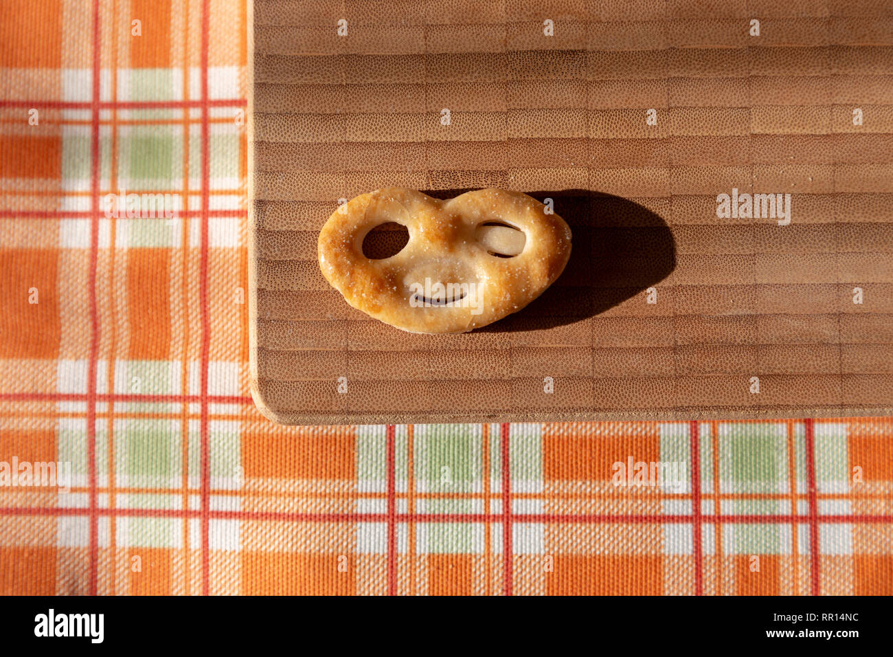Biscuit with a defect turns into smiley face Stock Photo - Alamy